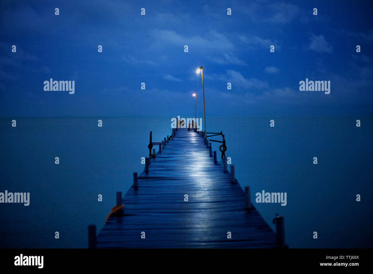 View of jetty at night Stock Photo - Alamy