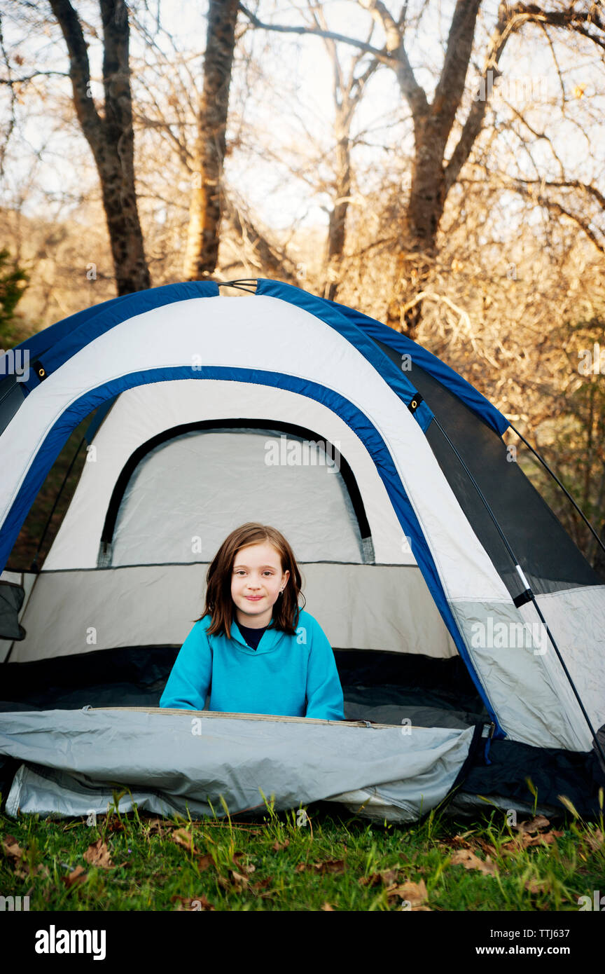 Portrait of girl sitting in tent Stock Photo - Alamy