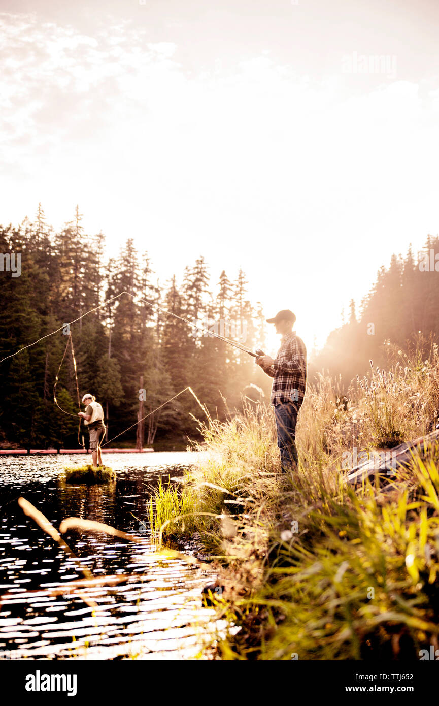 Family fishing reflection hi-res stock photography and images - Alamy