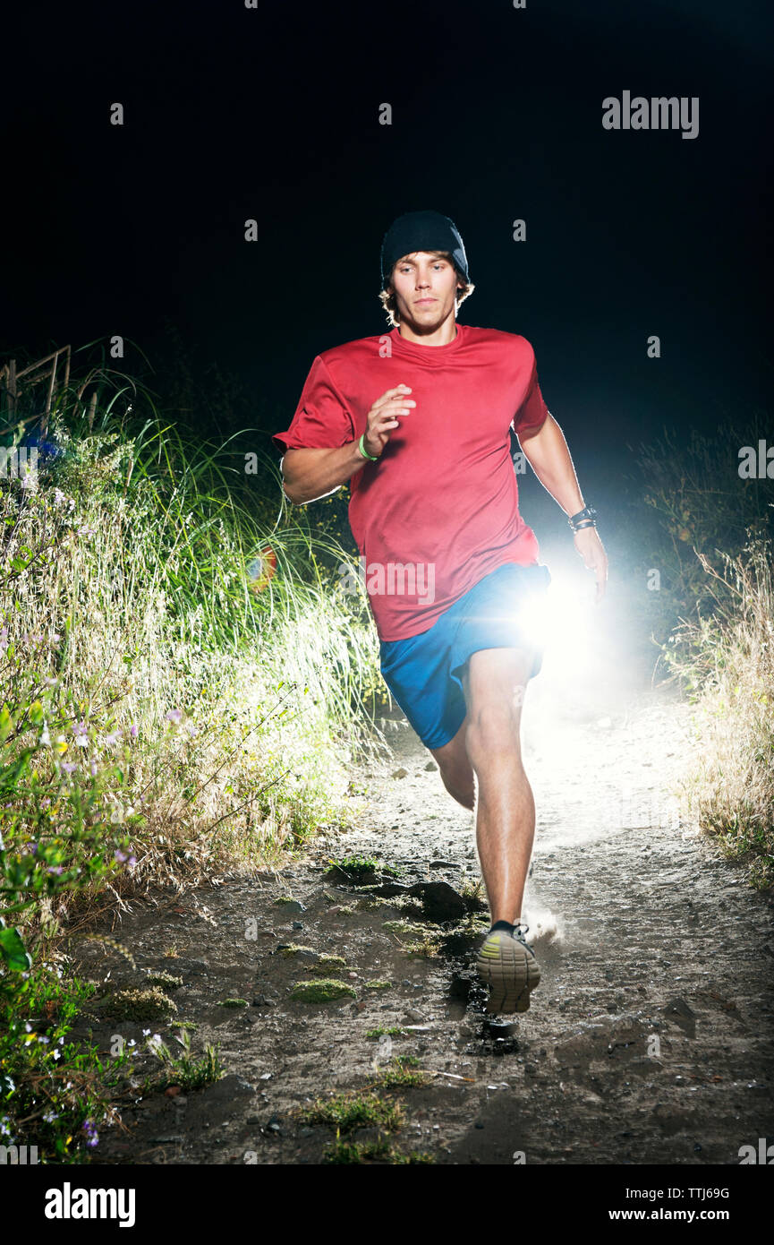 Man running on field at night Stock Photo - Alamy