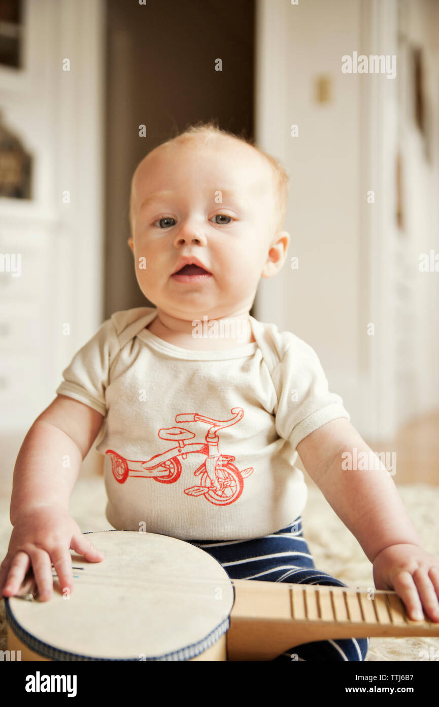 Portrait of cute boy holding toy Stock Photo - Alamy