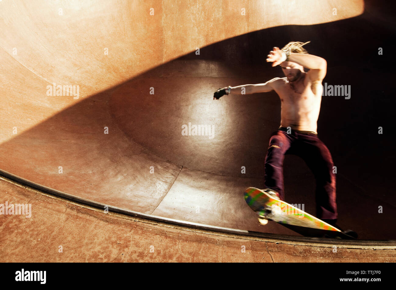 Shirtless man skateboarding on sports ramp Stock Photo - Alamy