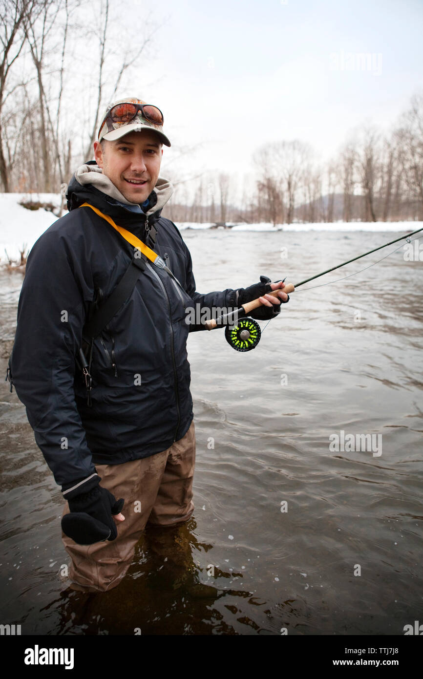 Portrait of man fishing in lake Stock Photo - Alamy