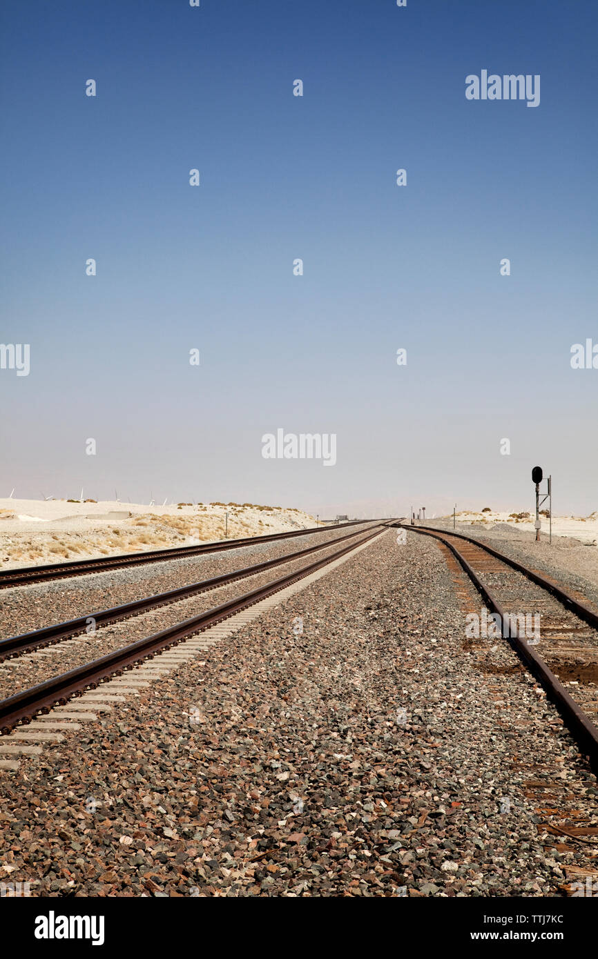 View of railroad tracks against clear sky Stock Photo - Alamy