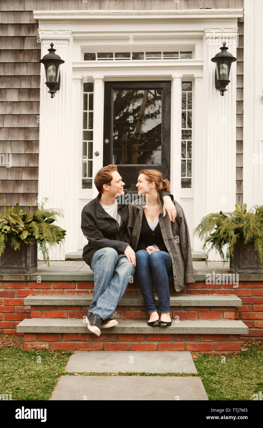 Young woman sitting on stoop hi-res stock photography and images - Alamy