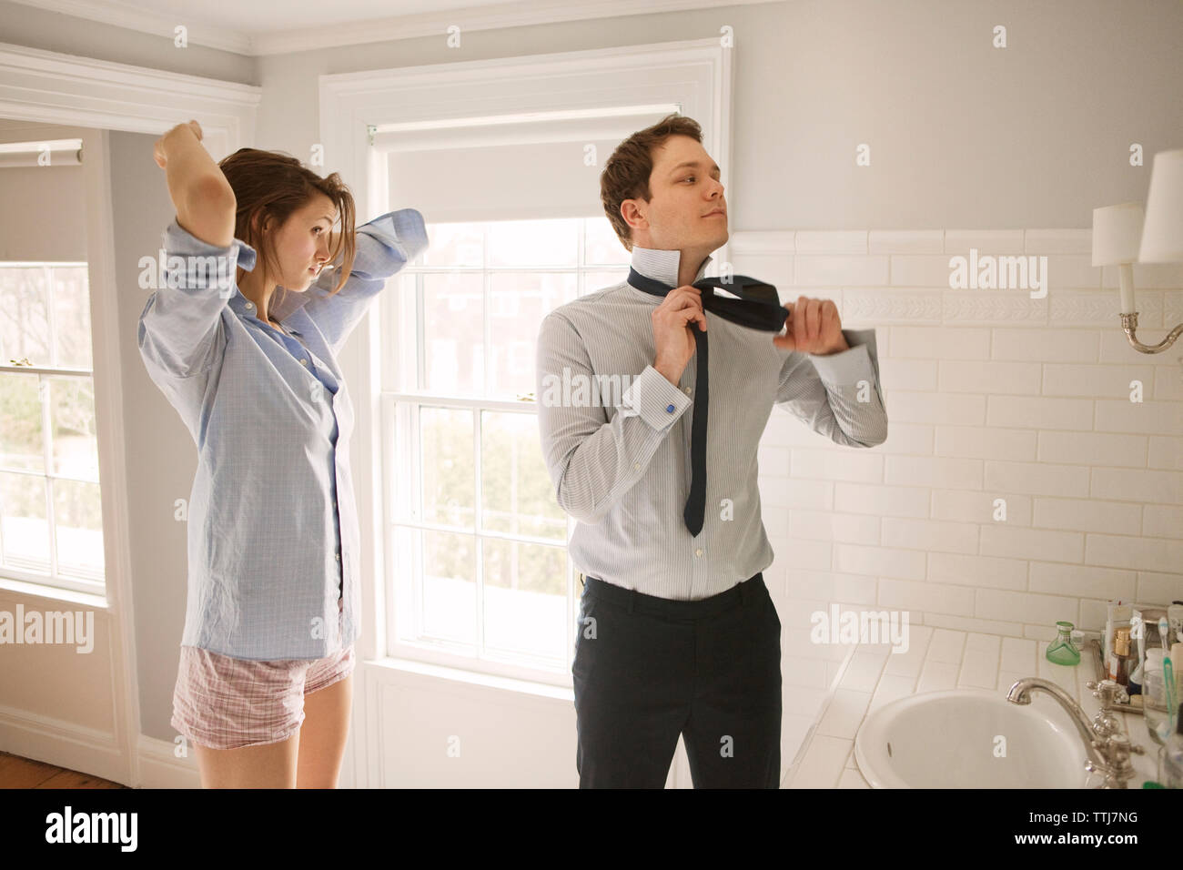 Caucasian couple getting dressed in hi-res stock photography and images ...