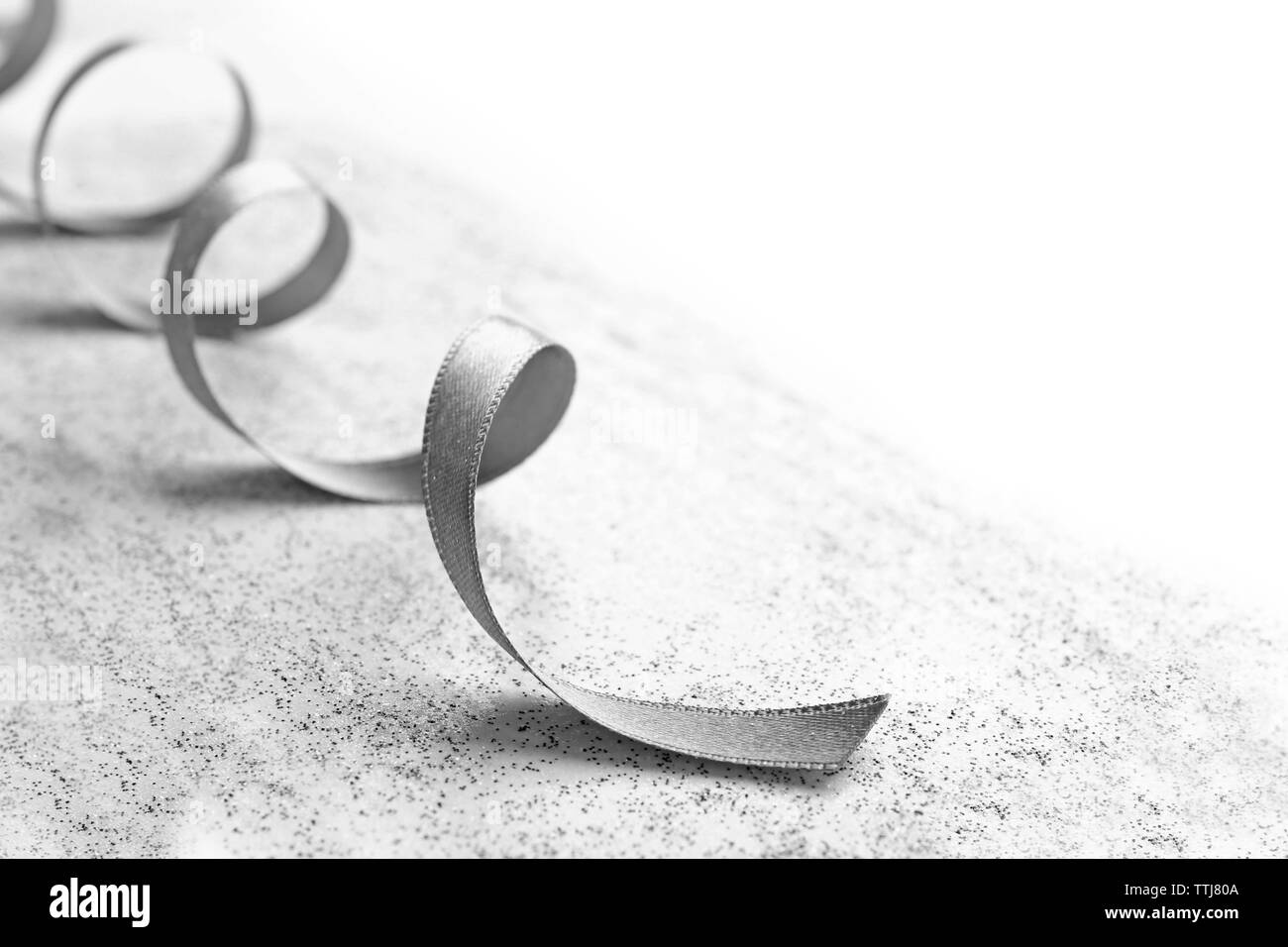 Grey ribbon on light textured background Stock Photo - Alamy