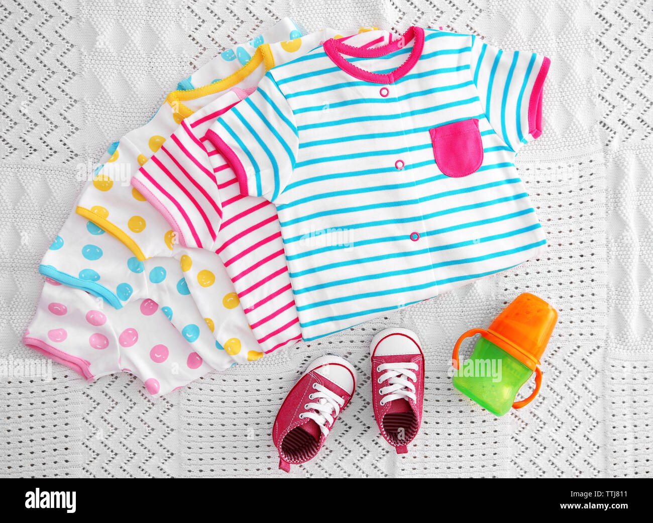 Baby clothes on fabric background Stock Photo - Alamy