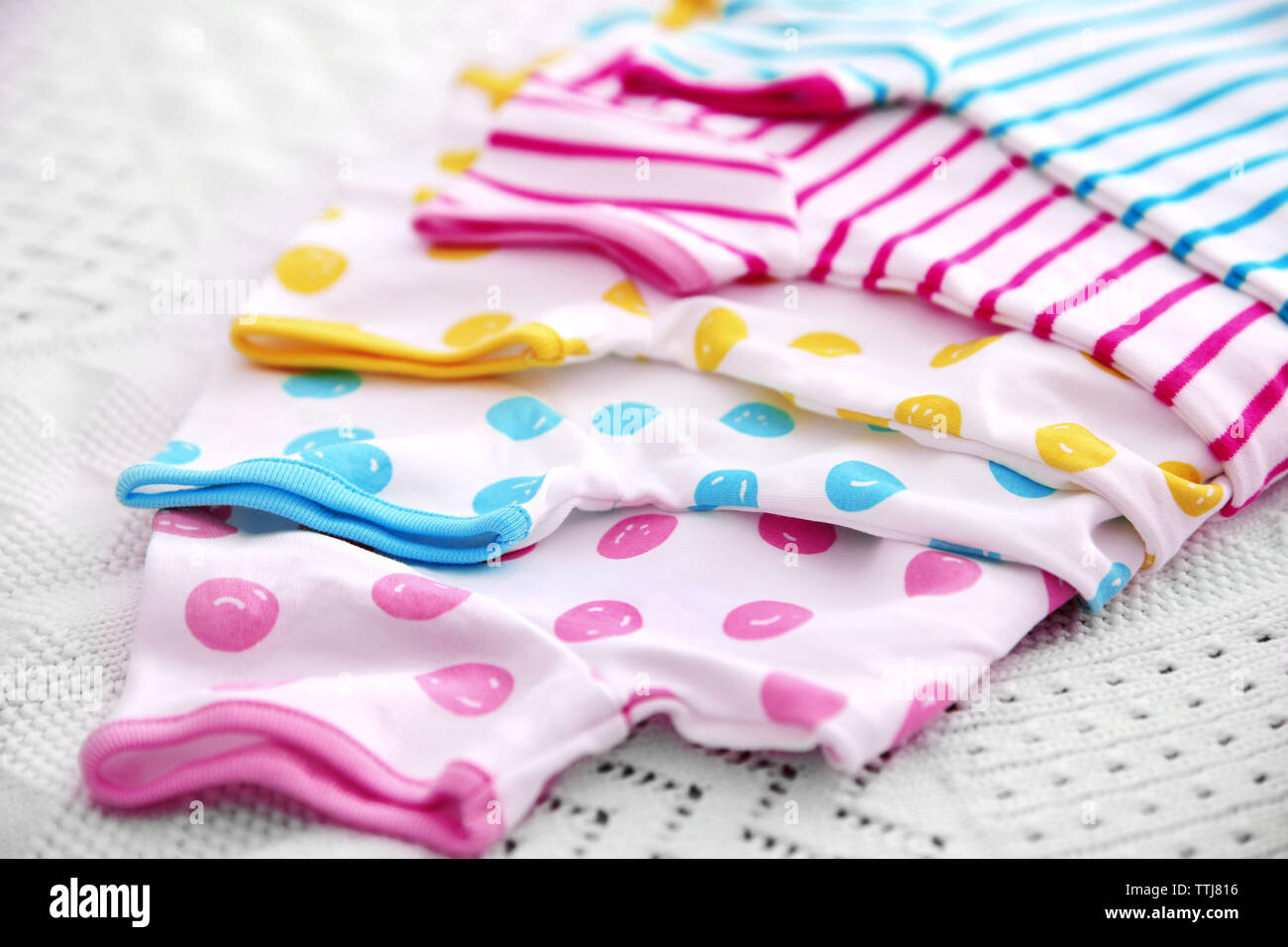 Baby clothes on fabric background Stock Photo - Alamy