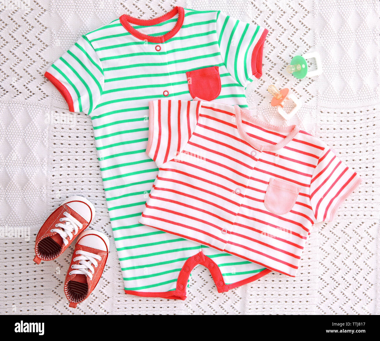 Baby clothes on fabric background Stock Photo - Alamy