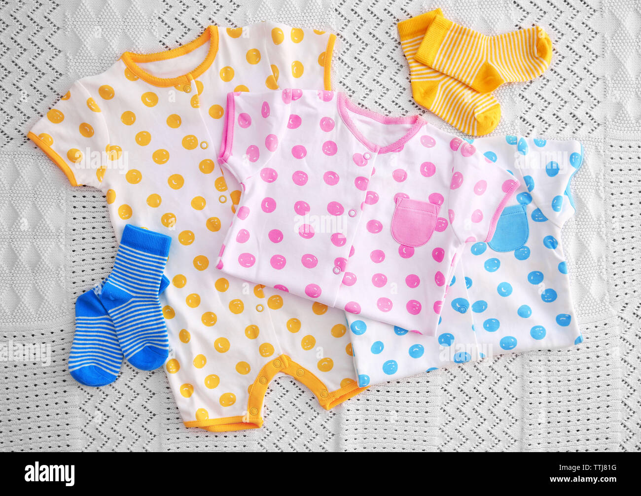 Baby clothes on fabric background Stock Photo - Alamy
