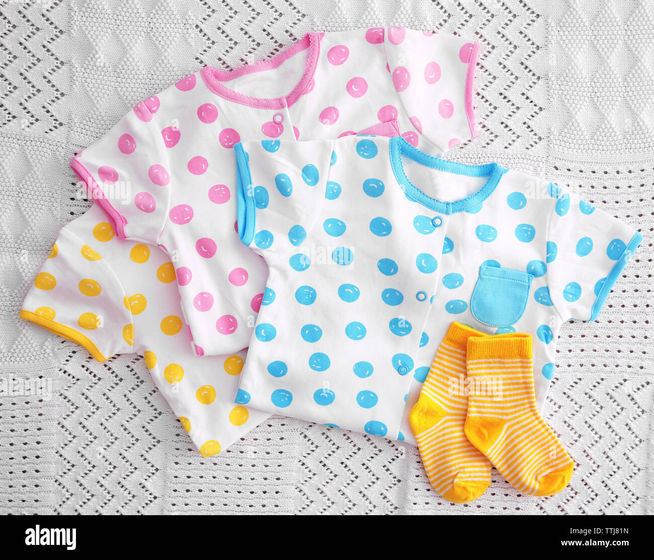Baby clothes on fabric background Stock Photo - Alamy