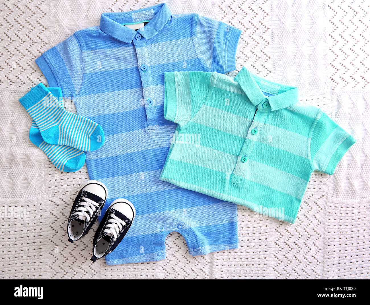 Baby clothes on fabric background Stock Photo - Alamy