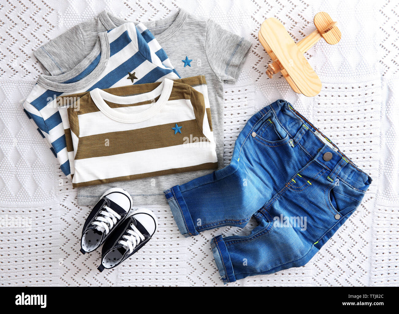 Baby clothes on fabric background Stock Photo - Alamy