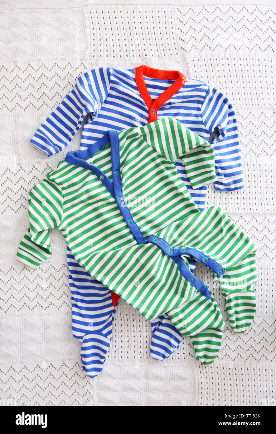 Baby clothes on fabric background Stock Photo - Alamy