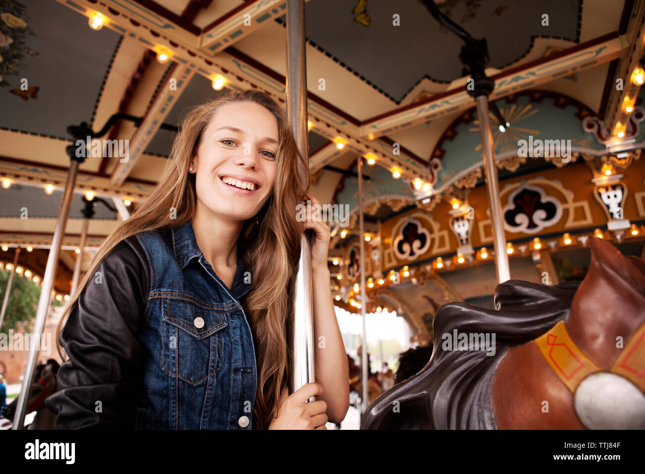 Young woman riding carousel hi-res stock photography and images - Alamy