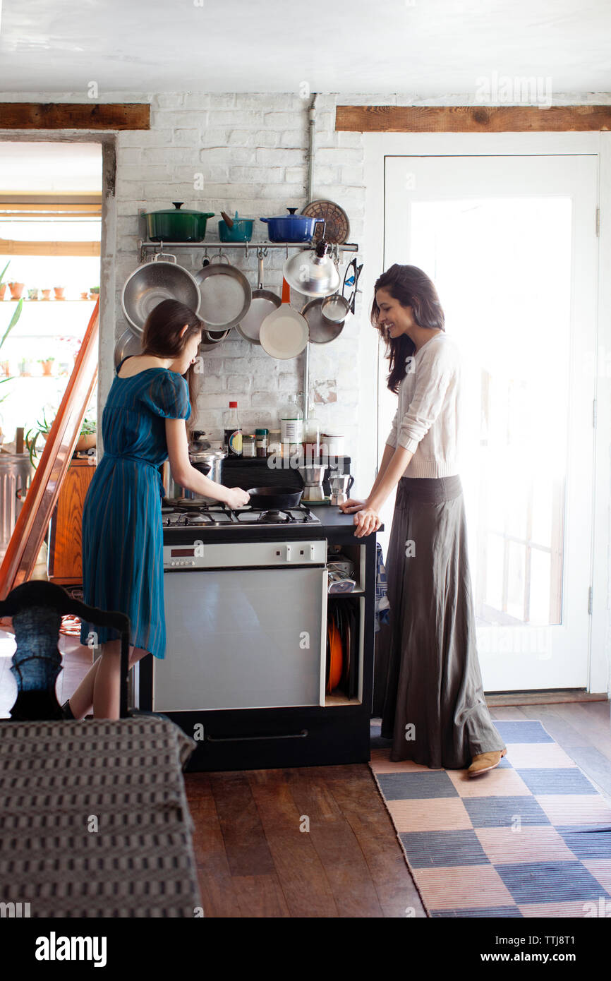 Happy sisters cooking at home Stock Photo - Alamy