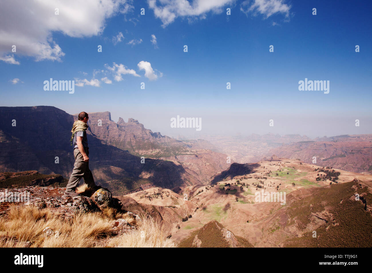 Side view of man standing on mountain Stock Photo - Alamy