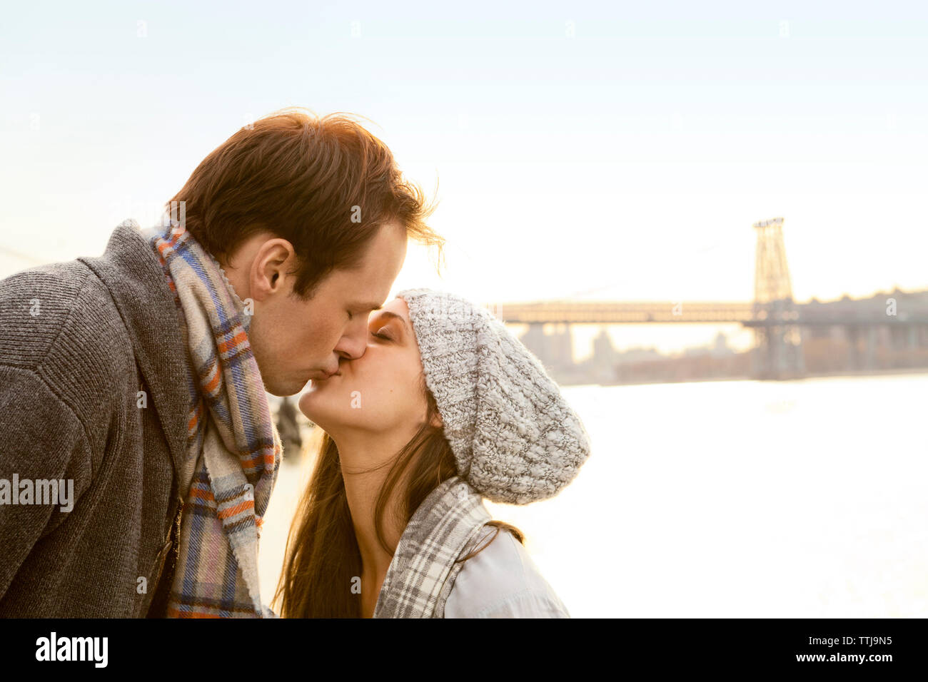 Young couple kissing against hi-res stock photography and images - Alamy