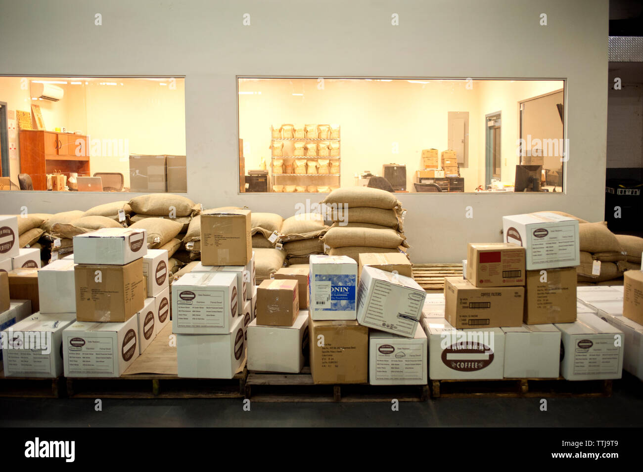 Cardboard boxes and sacks at warehouse Stock Photo - Alamy