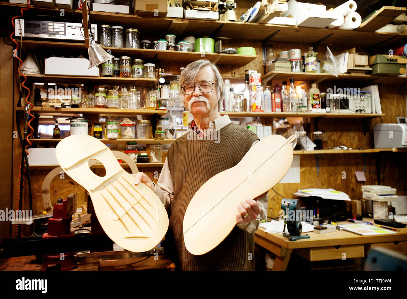 Portrait of man holding incomplete guitar at workshop Stock Photo - Alamy