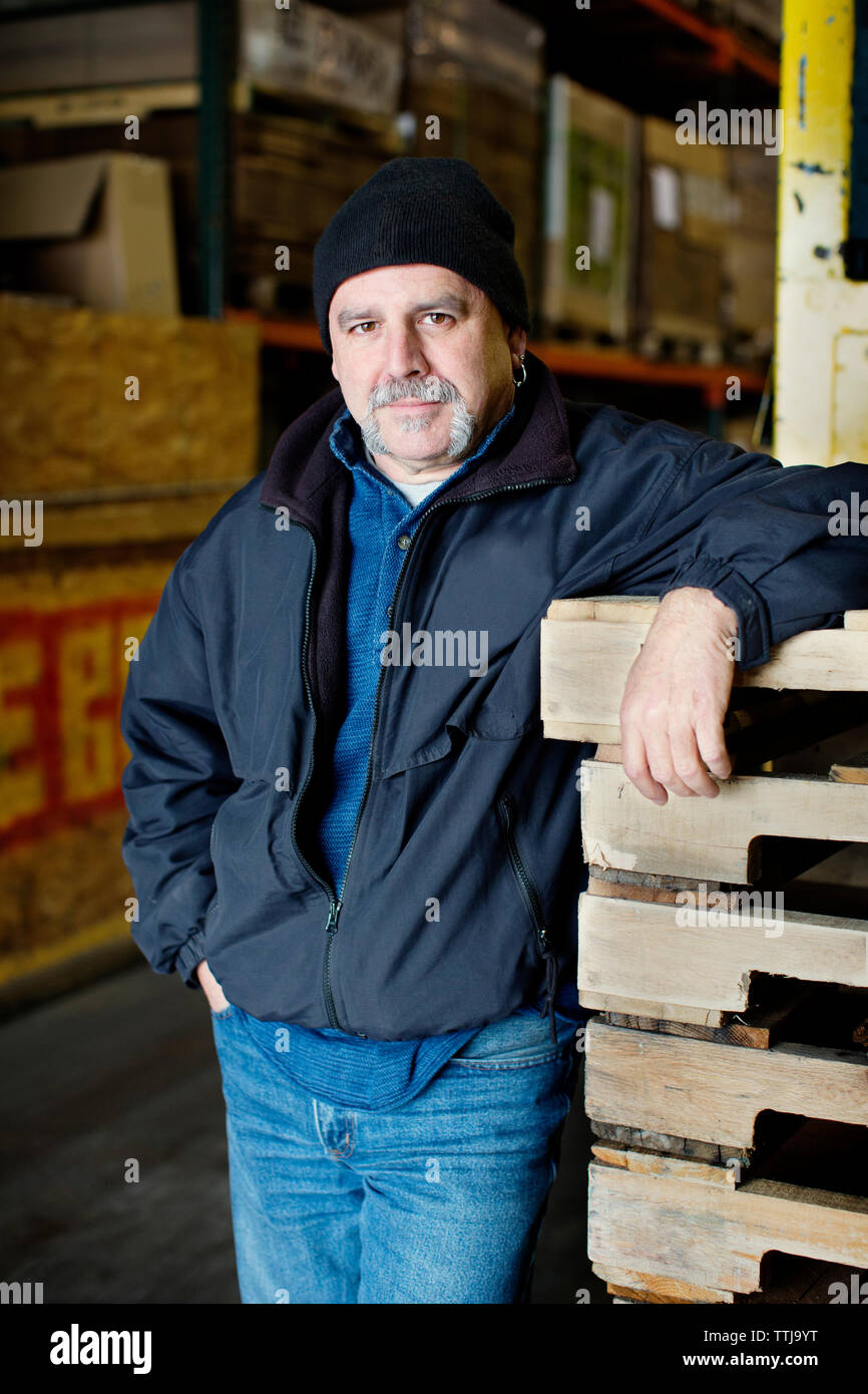 Portrait of confident worker standing at warehouse Stock Photo - Alamy