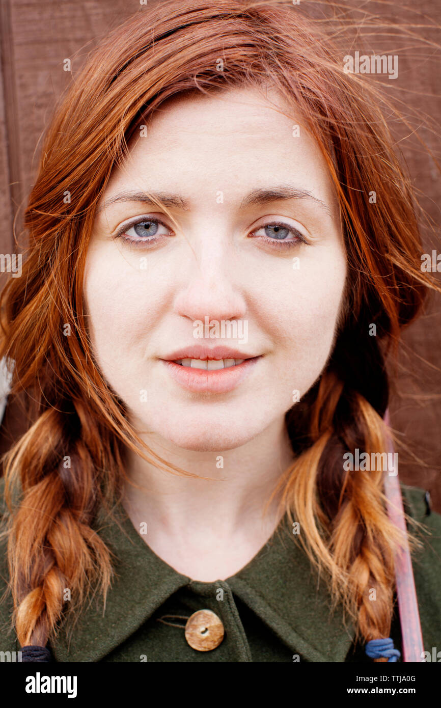 Woman standing against wall hi-res stock photography and images - Alamy