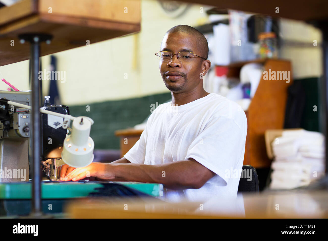 Portrait of worker sewing in factory Stock Photo - Alamy