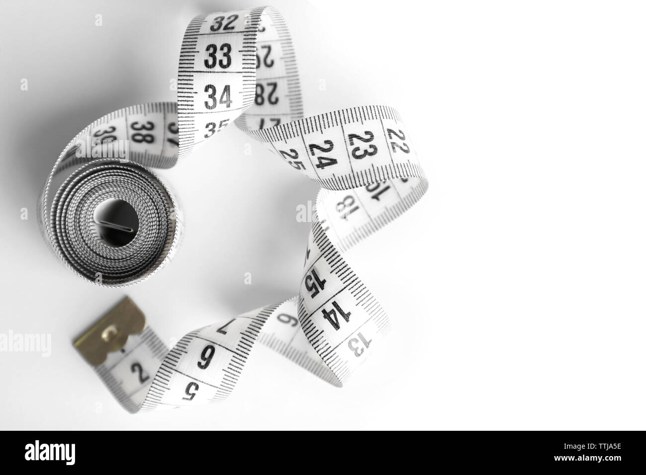 Measuring tape on white background Stock Photo - Alamy