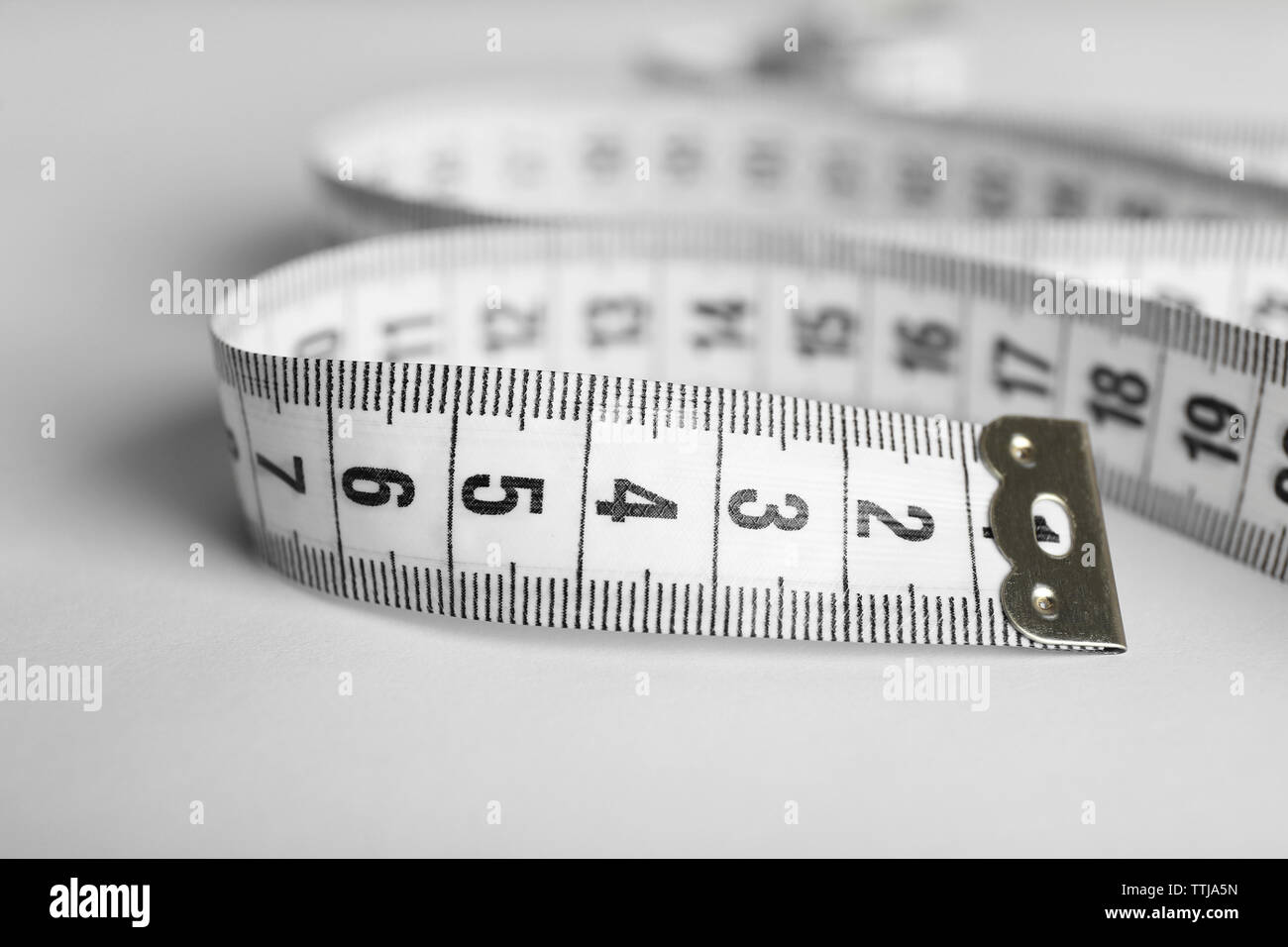 Measuring tape on white background Stock Photo - Alamy