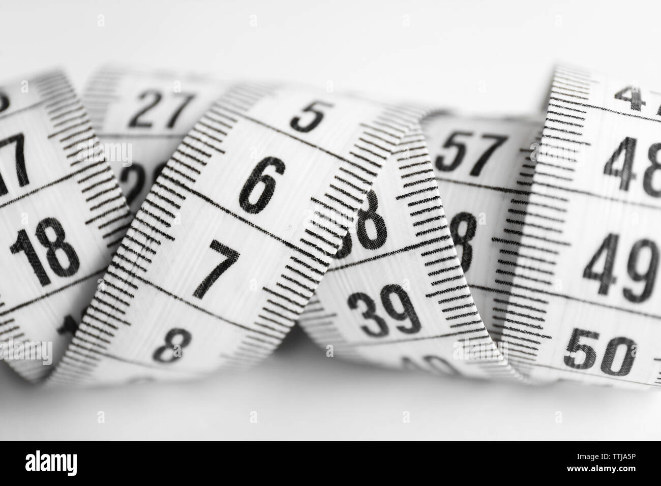 Measuring tape on white background Stock Photo - Alamy