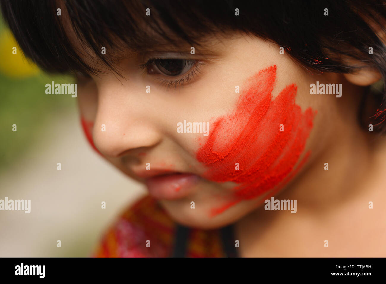 Red gulal on a girls face Stock Photo - Alamy