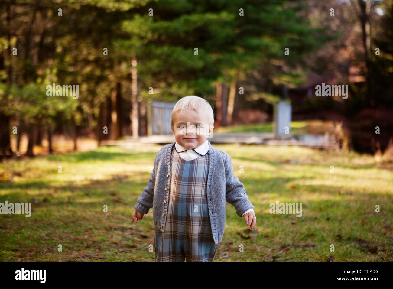 Happy baby boy standing on field Stock Photo - Alamy