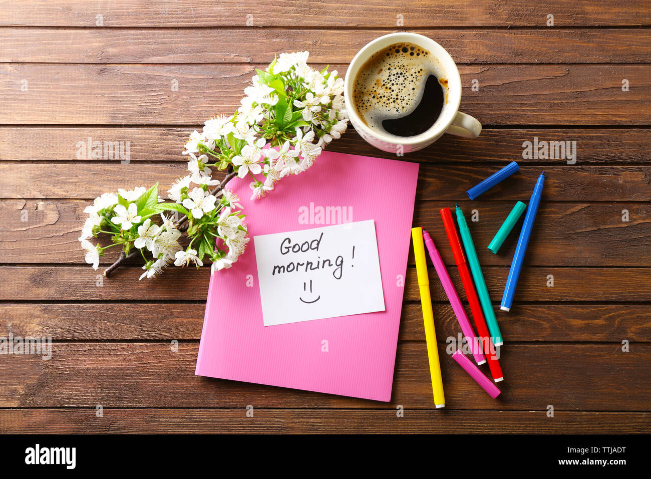 Cup of fresh coffee and note on wooden background Stock Photo - Alamy