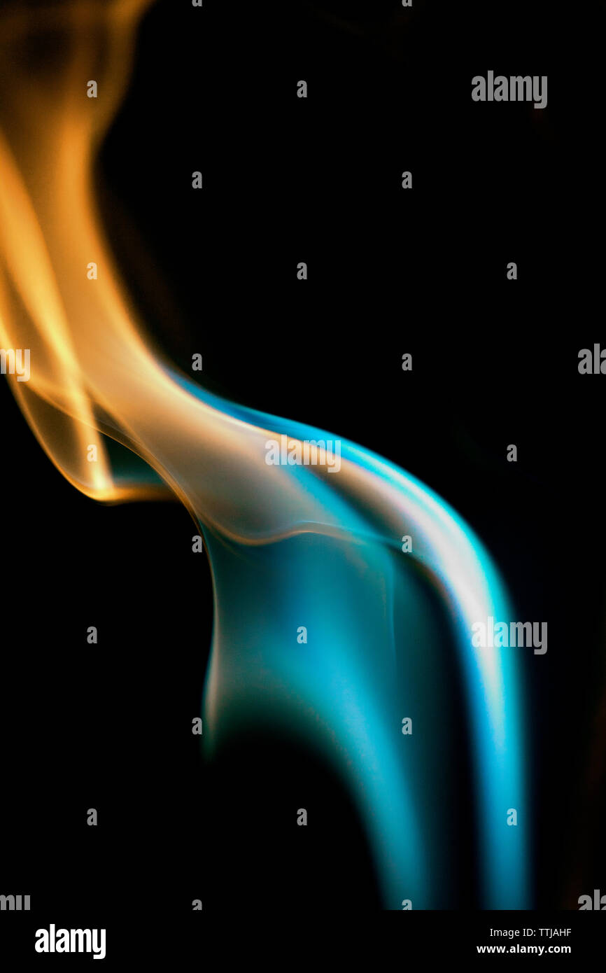 Smoke glowing against black background Stock Photo - Alamy
