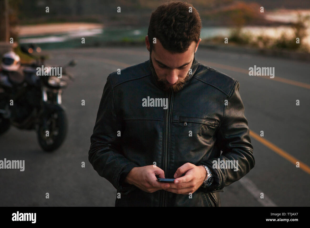 Handsome man standing using hi-res stock photography and images - Alamy