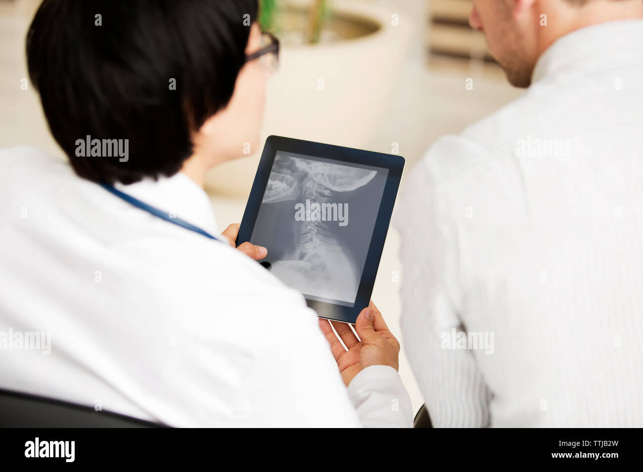 Doctors looking x-ray report in tablet computer Stock Photo - Alamy