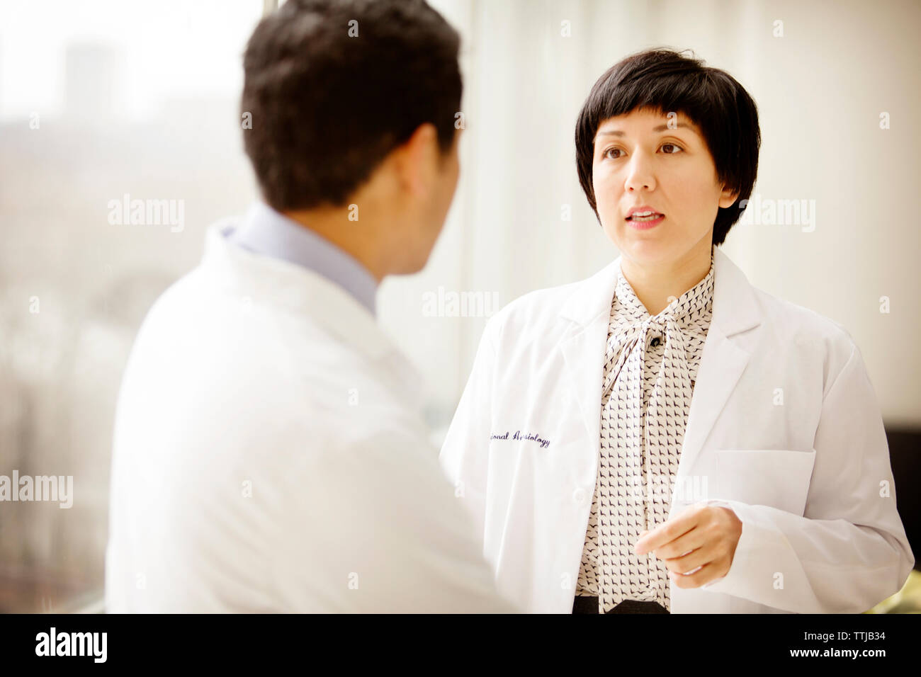Doctors discussing in hospital Stock Photo - Alamy