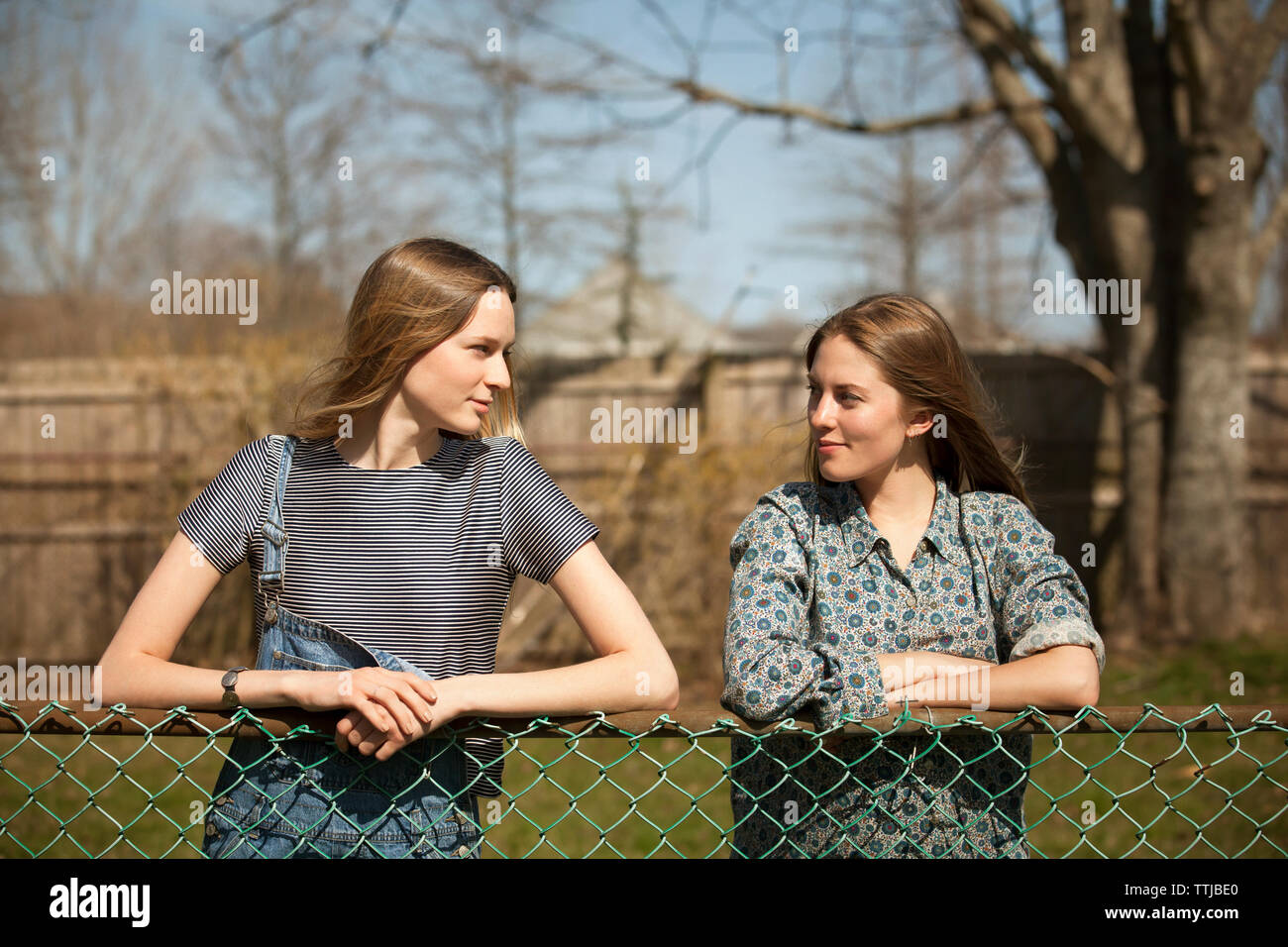 Women talking fence hi-res stock photography and images - Alamy