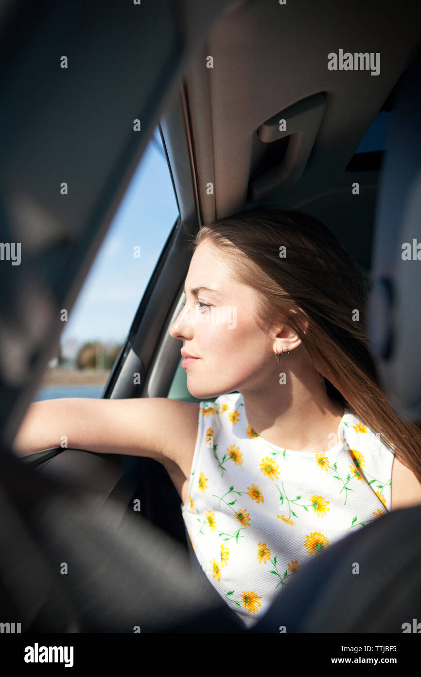 Woman looking through car window while traveling Stock Photo - Alamy