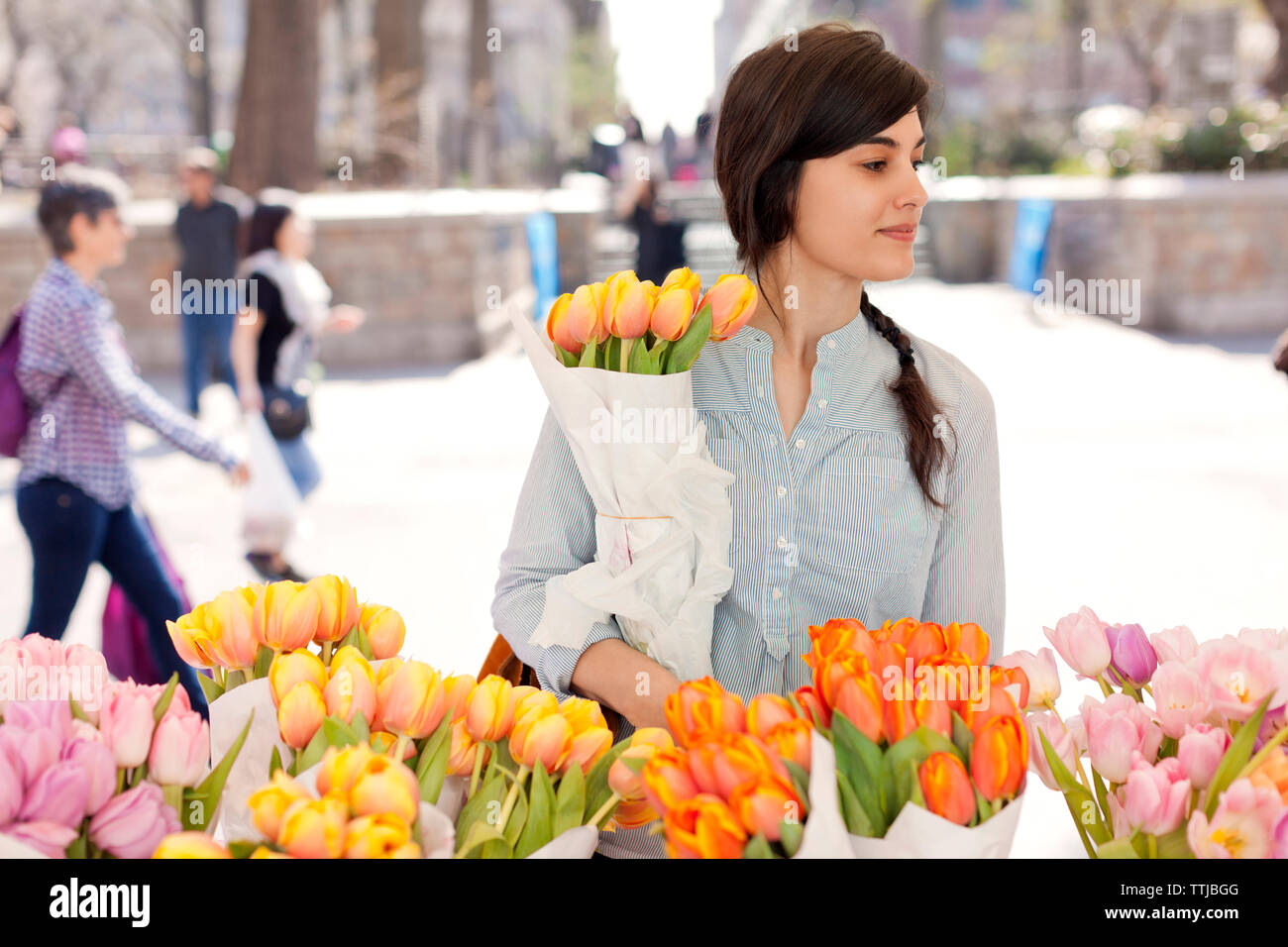 Smiling female choosing flowers hi-res stock photography and images - Alamy