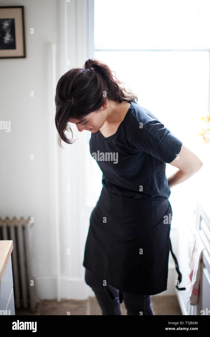 Woman wearing apron in kitchen hi-res stock photography and images - Alamy