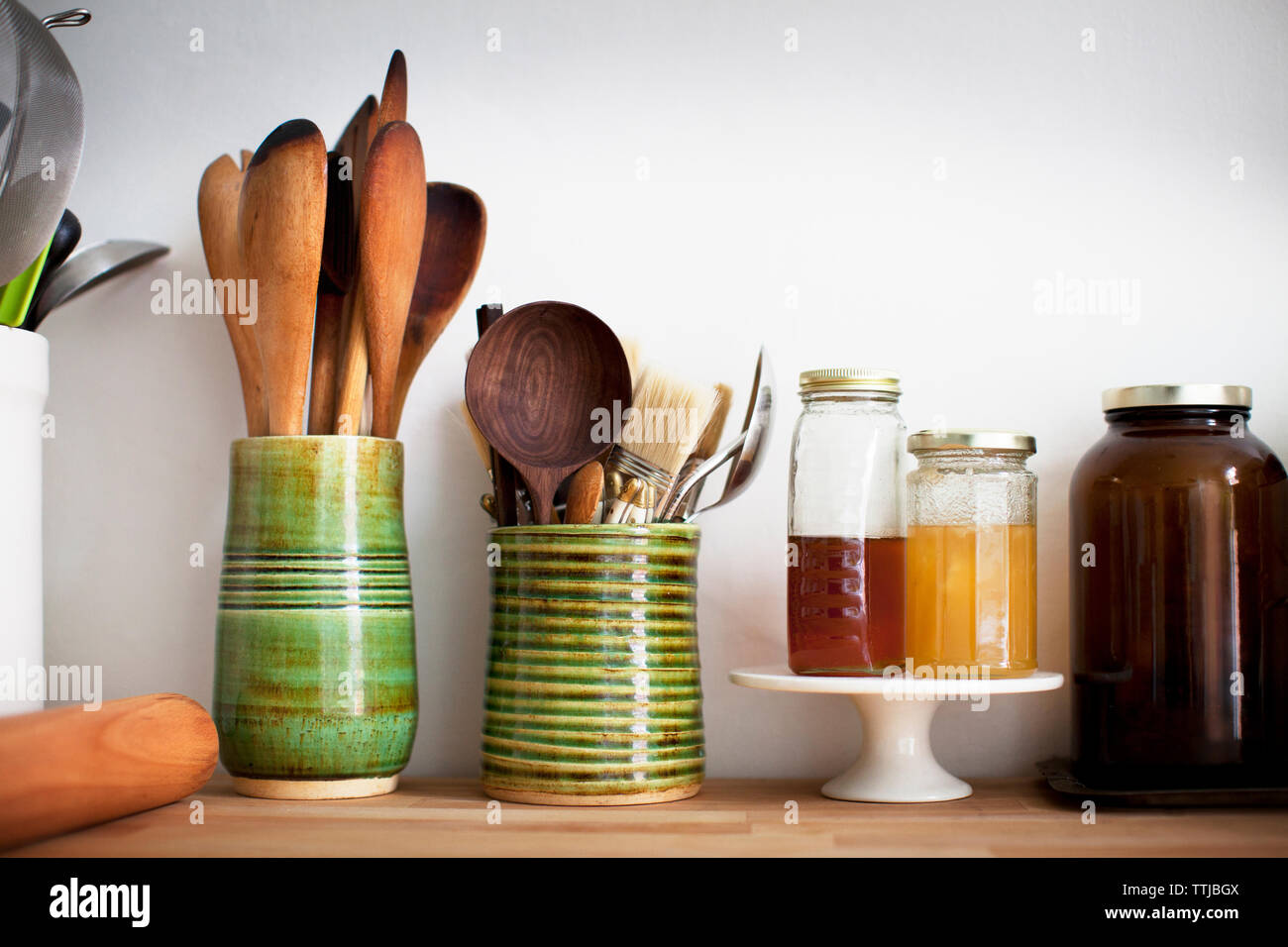 Kitchen utensils on kitchen counter against wall at home Stock Photo ...