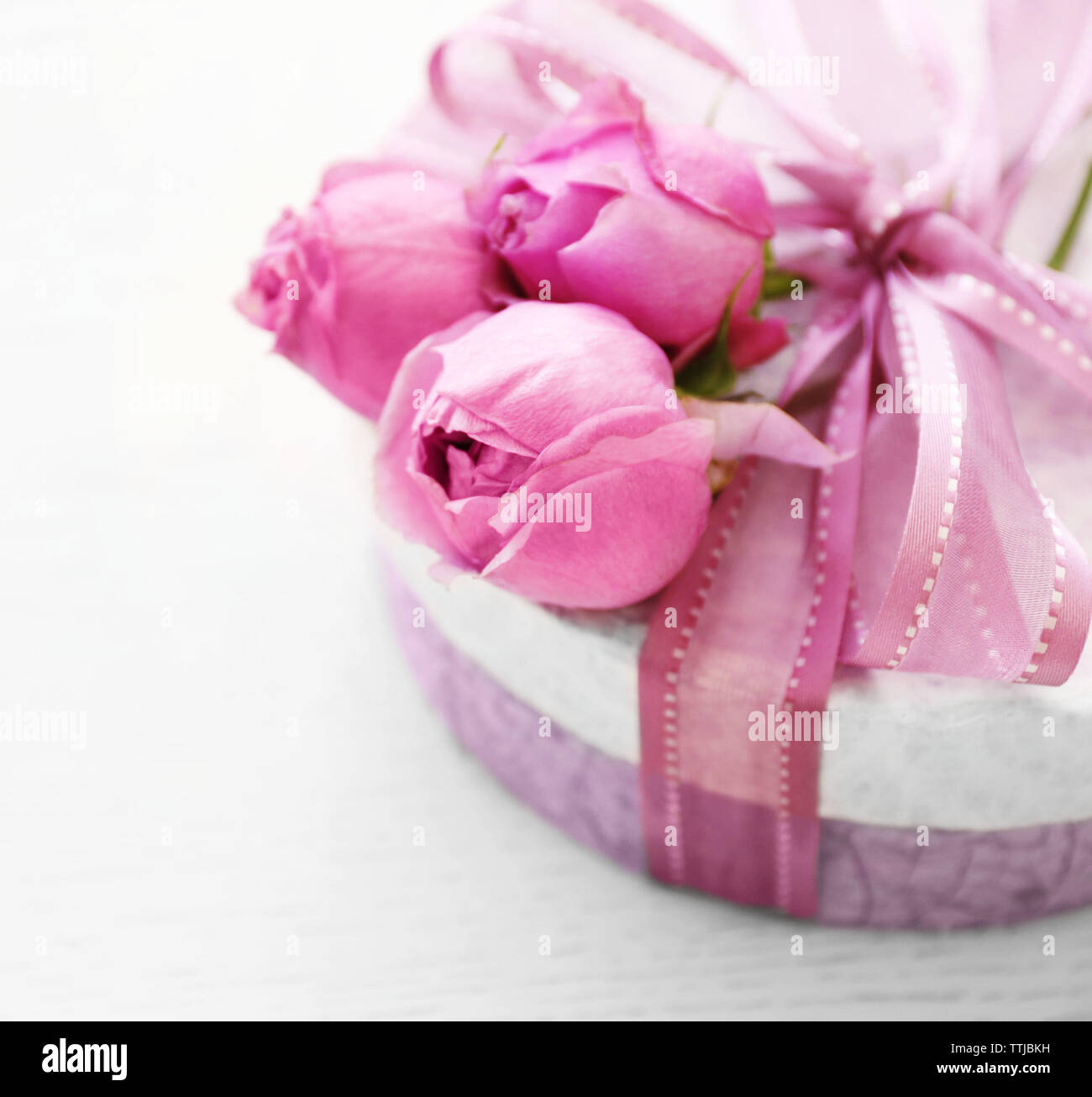 Gift box with beautiful roses on wooden background Stock Photo - Alamy