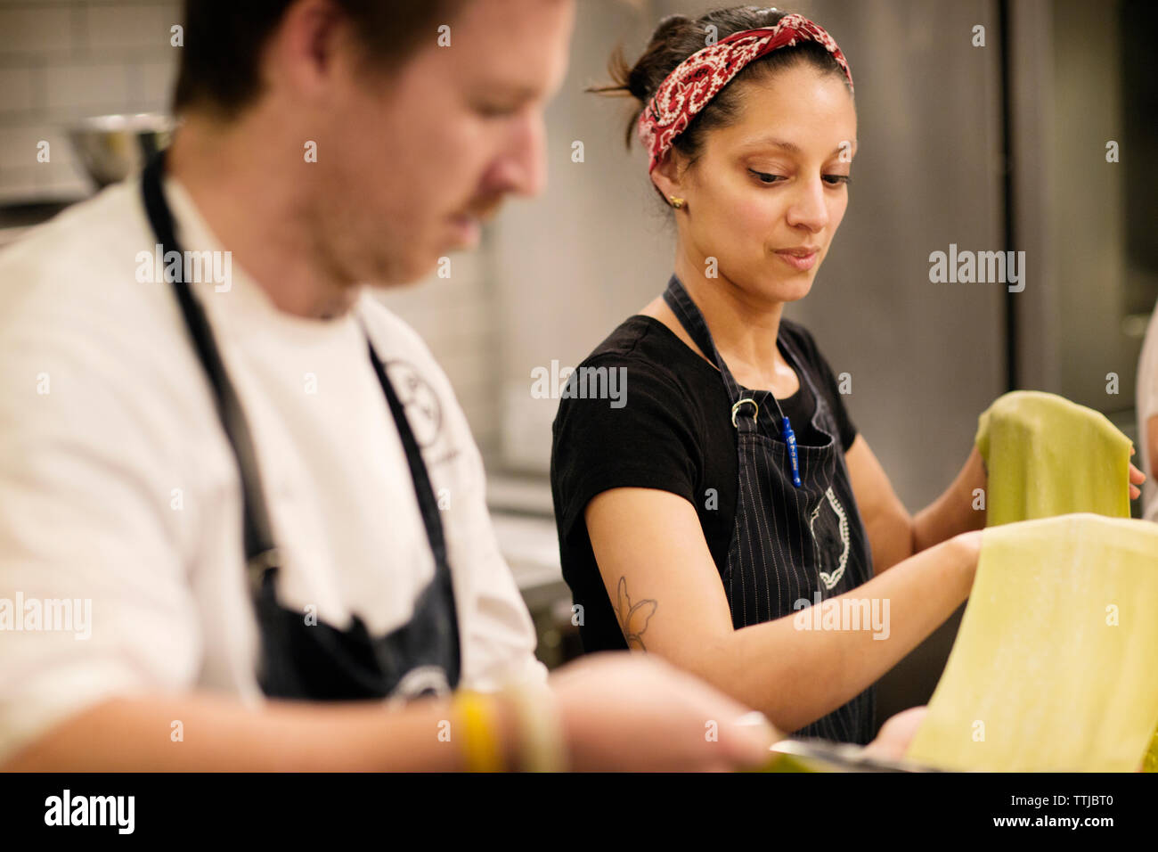 Chefs preparing pasta at commercial kitchen Stock Photo - Alamy