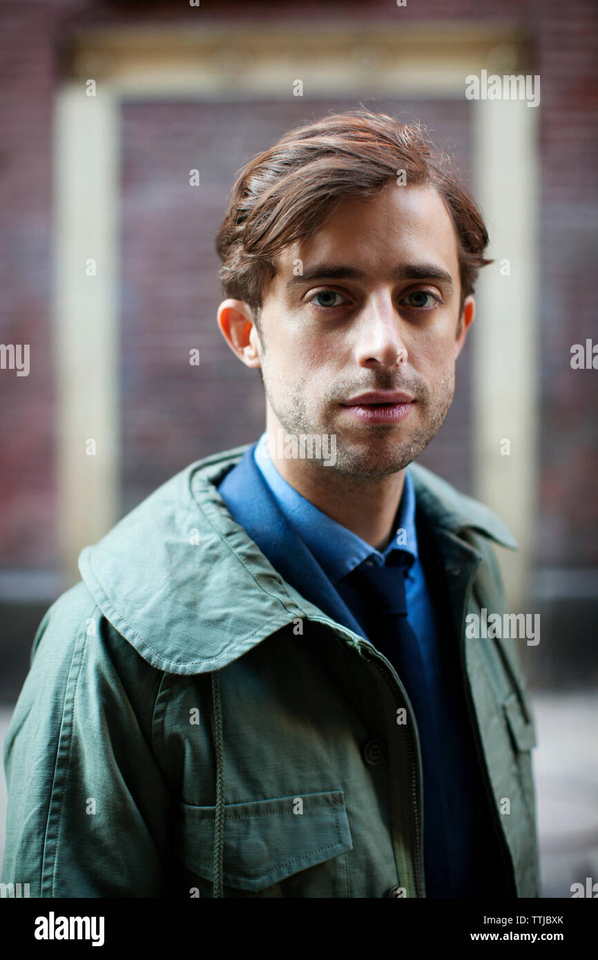 Portrait of man standing at street Stock Photo - Alamy