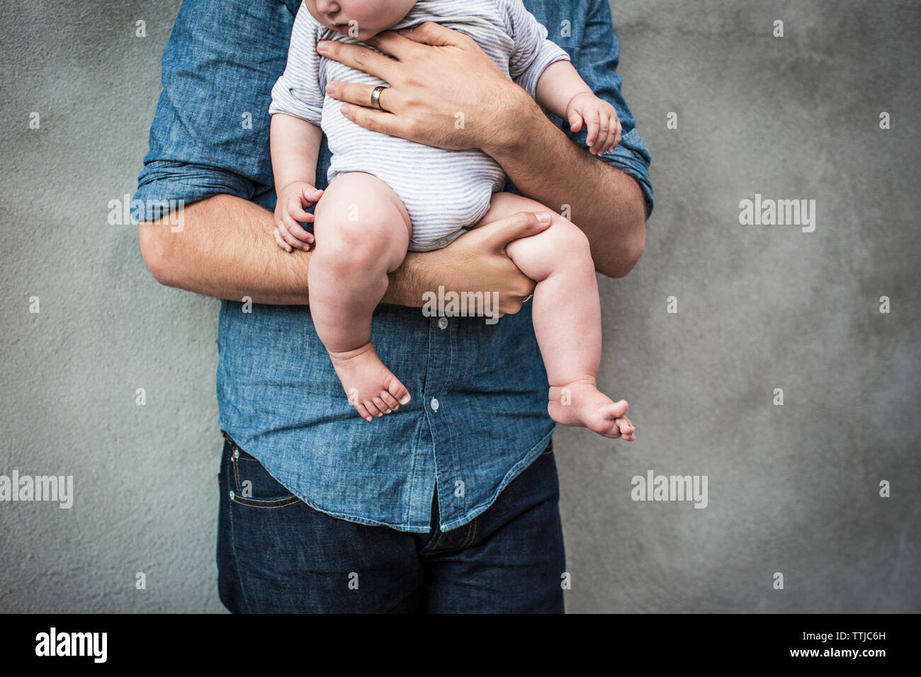 Man carrying baby hi-res stock photography and images - Alamy