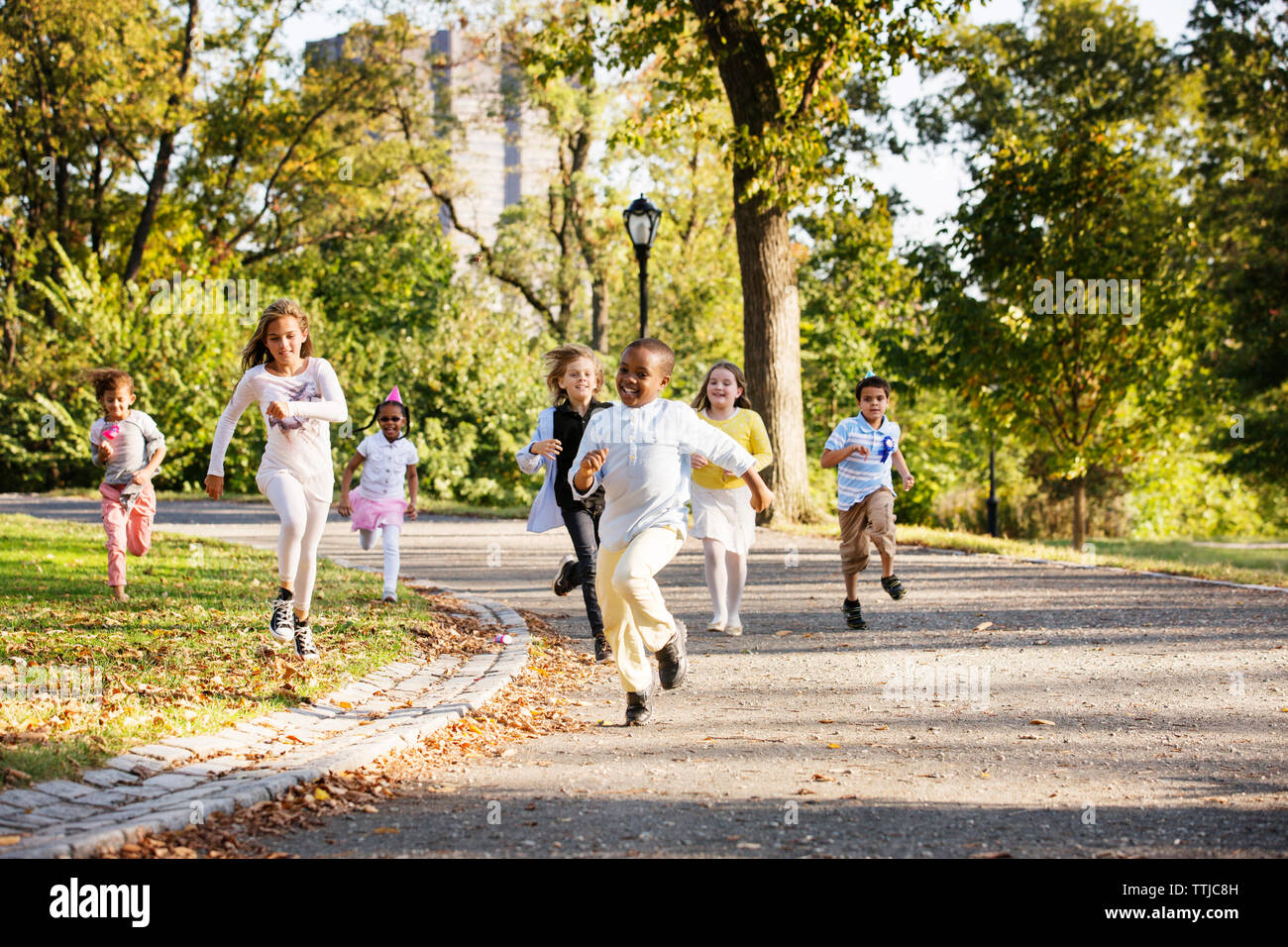 Happy children running at park Stock Photo - Alamy