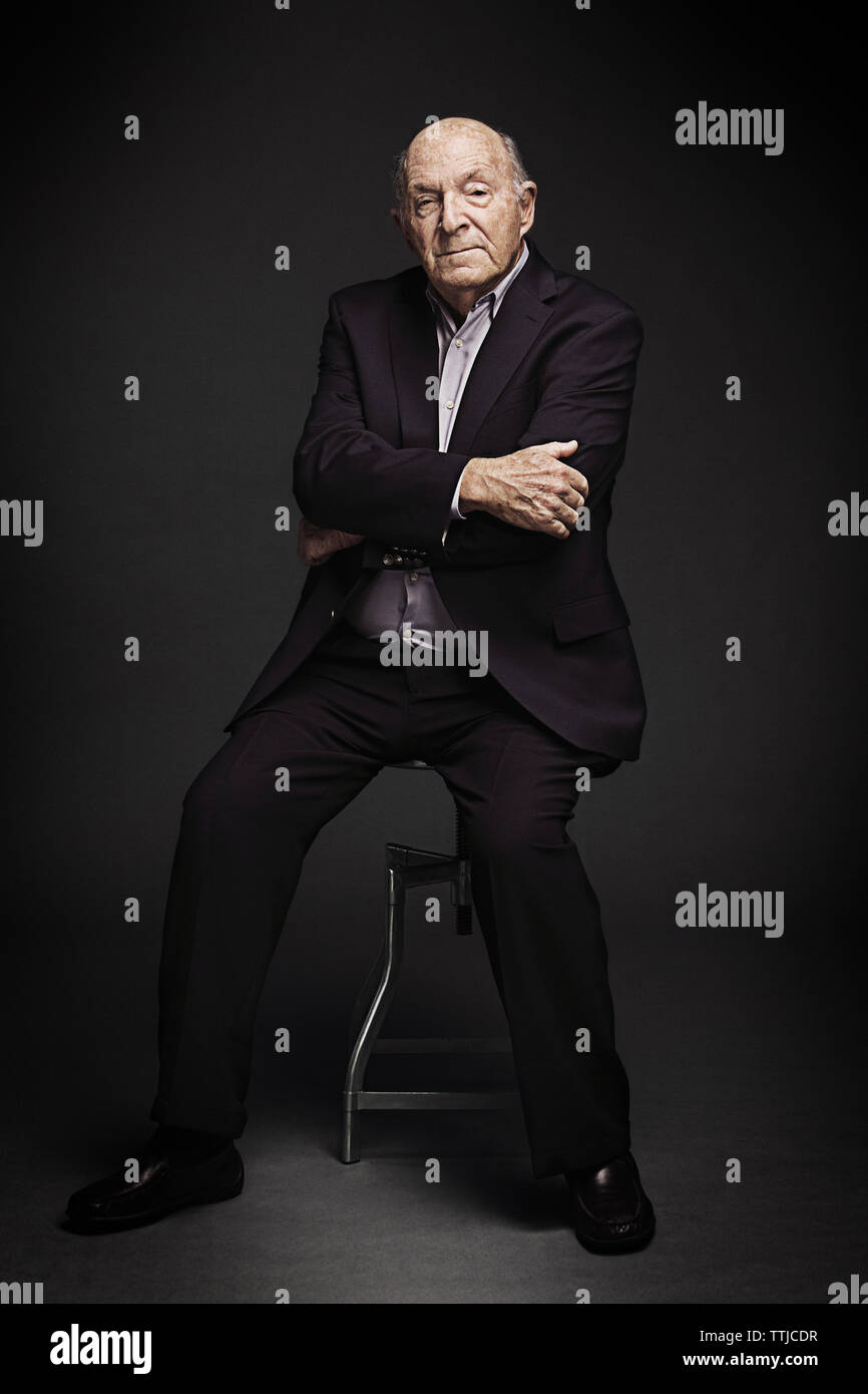 Serious man sitting on stool hi-res stock photography and images - Alamy