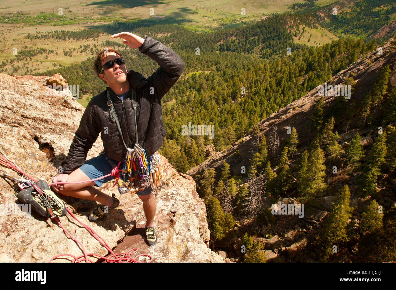 Man looking up while standing on cliff Stock Photo - Alamy